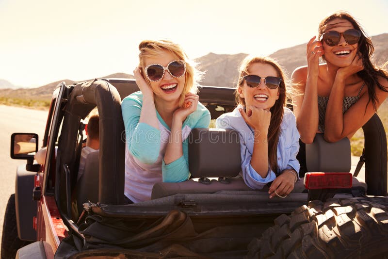 Three Female Friends on Road Trip in Back of Convertible Car Stock ...