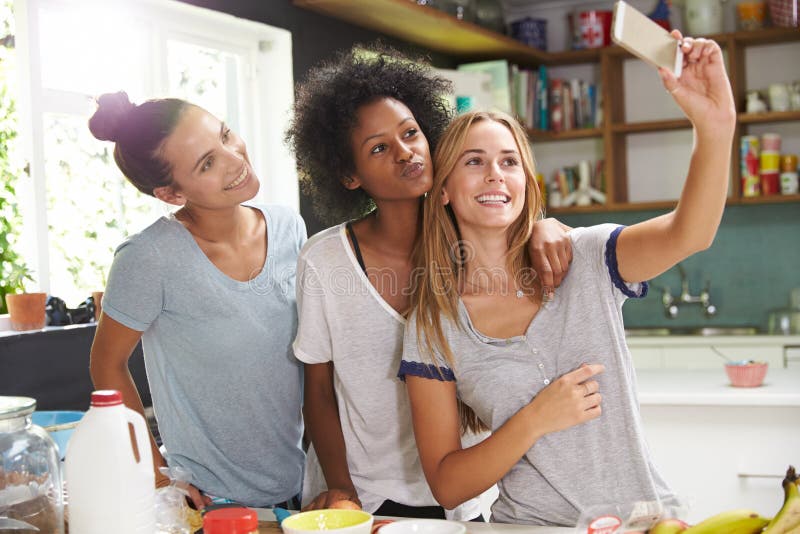 Three Female Friends Taking Selfie Whilst Making Breakfast Stock Image ...