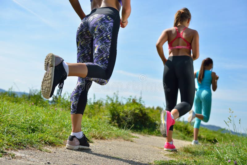 Three Female Joggers Running Together Outdoors Stock Image - Image of ...