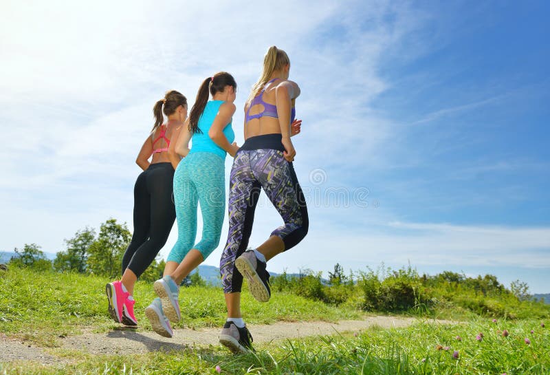 Three Female Joggers Running Together Outdoors Stock Photo - Image of ...