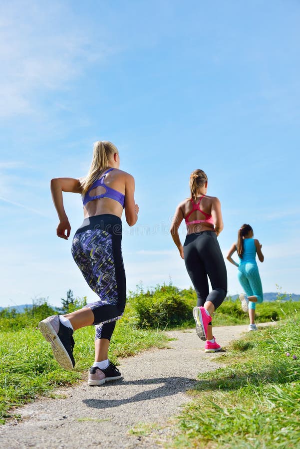 Three Female Joggers Running Together Outdoors Stock Image - Image of ...