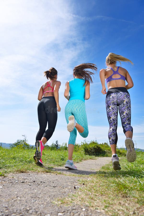 Three Female Joggers Running Together Outdoors Stock Photo - Image of ...