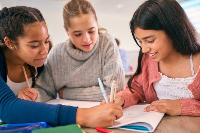 Three Female Secondary or High School Students Collaborating in Study ...