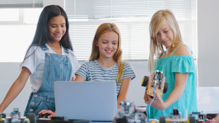 Three Female Students Building and Programming Robot Vehicle in after ...