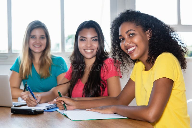 Three Female Students Learning at Classroom Stock Image - Image of ...