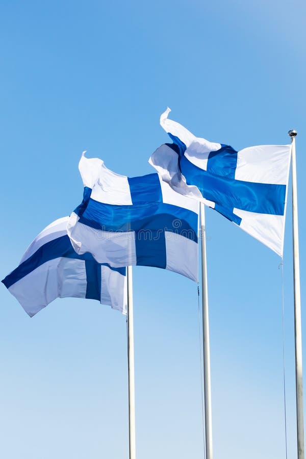 Three Finnish National Flags on the Wind Against the Blue Sky Stock ...