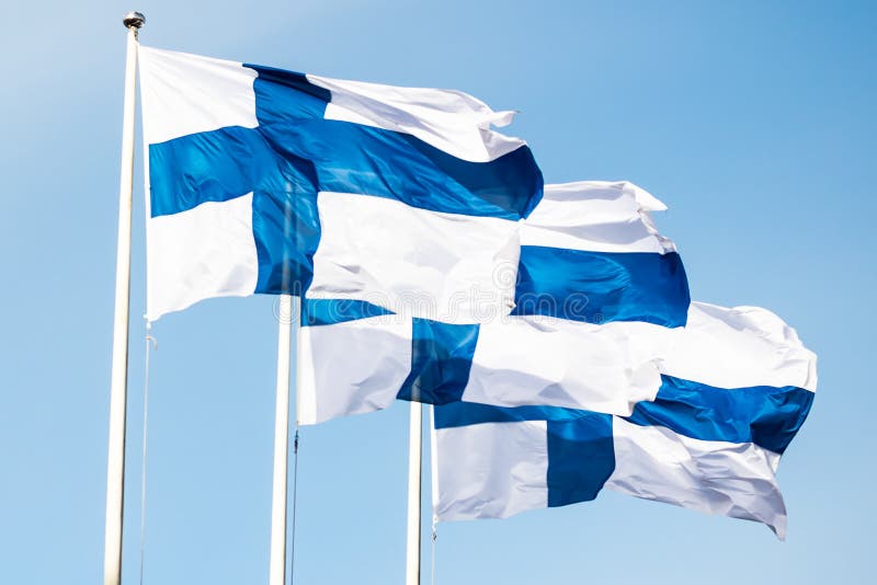 Three Finnish National Flags on the Wind Against the Blue Sky Stock ...