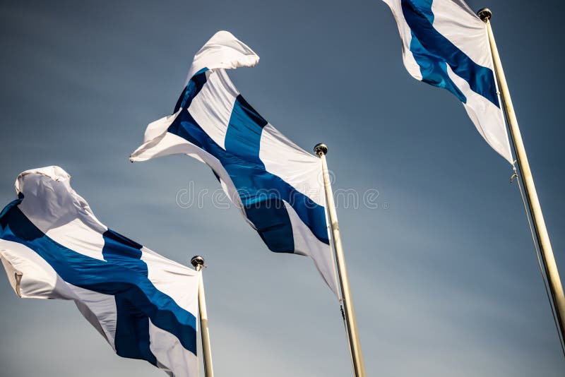 Three Finnish National Flags on the Wind Against the Blue Sky Stock ...