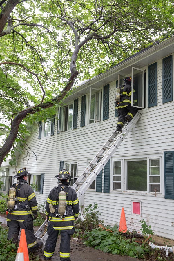 Three Firefighters on Fire Scene in Front of a Building Editorial Stock ...