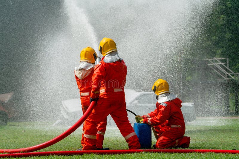 Close Up Firefighter Team with Three Man Support Together To ...