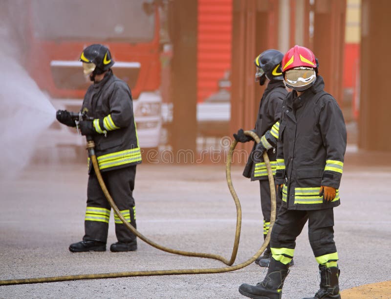 Three Firemen with the Mask Extinguish a Fire Editorial Photography ...