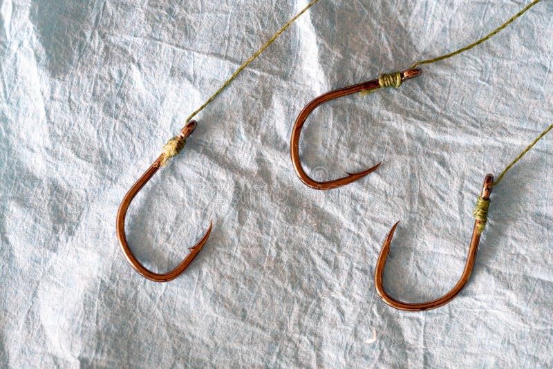 Three Fishing Hooks on Crumpled Paper Stock Photo - Image of fisherman ...
