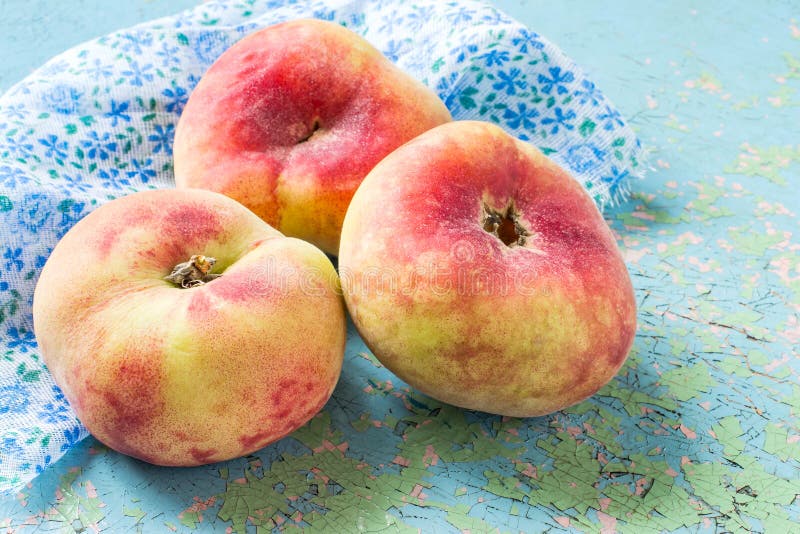 Three flat peaches stock photo. Image of peach, pleasure - 72949098