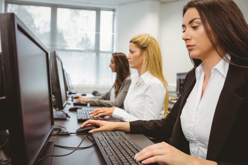 Three Focused Women Working in Computer Room Stock Image - Image of ...