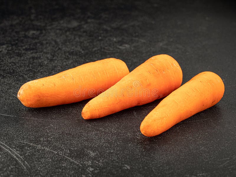Three Fresh Carrots on Grey Stock Photo - Image of gastronomy ...