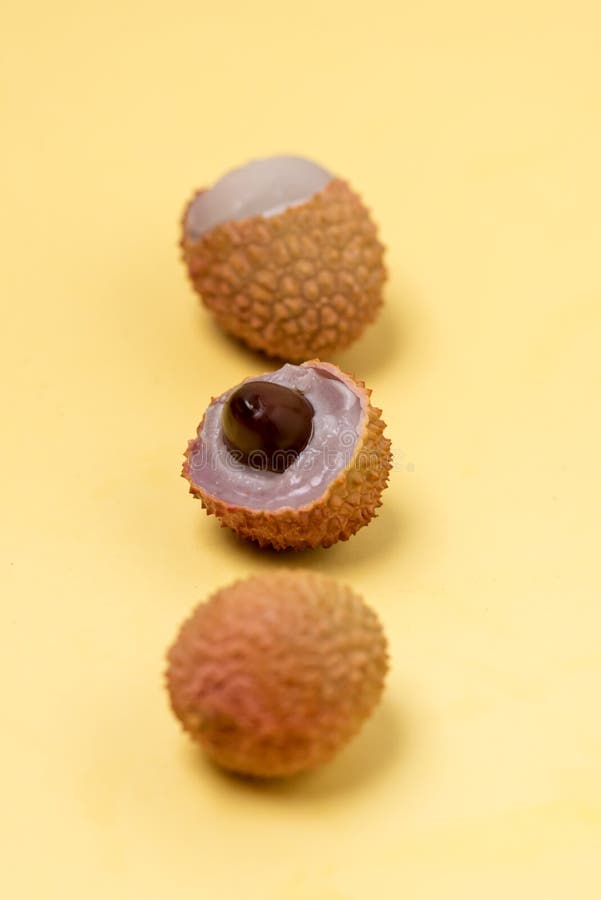 Three Fresh Organic Lychee Fruit on Yellow Background Vertical Stock ...