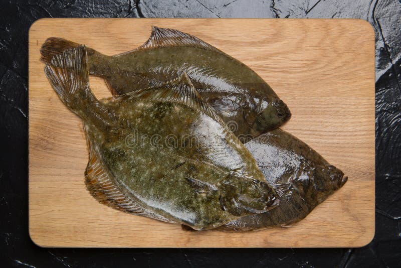 Three Fresh Raw Flounders on an Oak Cutting Board, Sea Fish Stock Photo ...