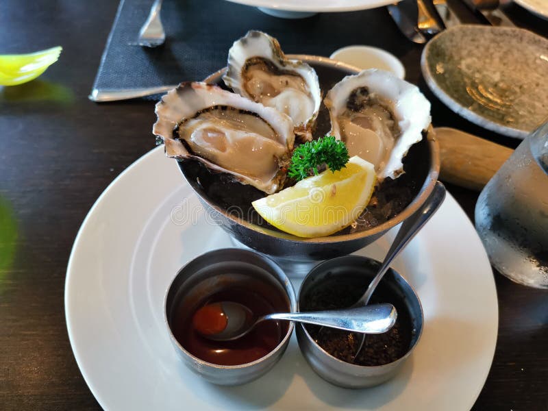 Three Fresh Raw Oysters With Tabasco Chilli Sauce And Red Wine Stock Image Image Of Fresh
