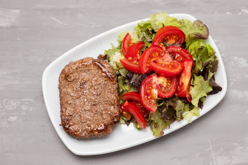 Three Fried Ground Meat with Fresh Salad on White Plate Stock Image ...