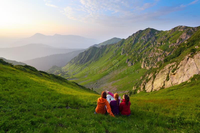 Three Friend Looking upon a Map and Landscapes. Stock Image - Image of ...