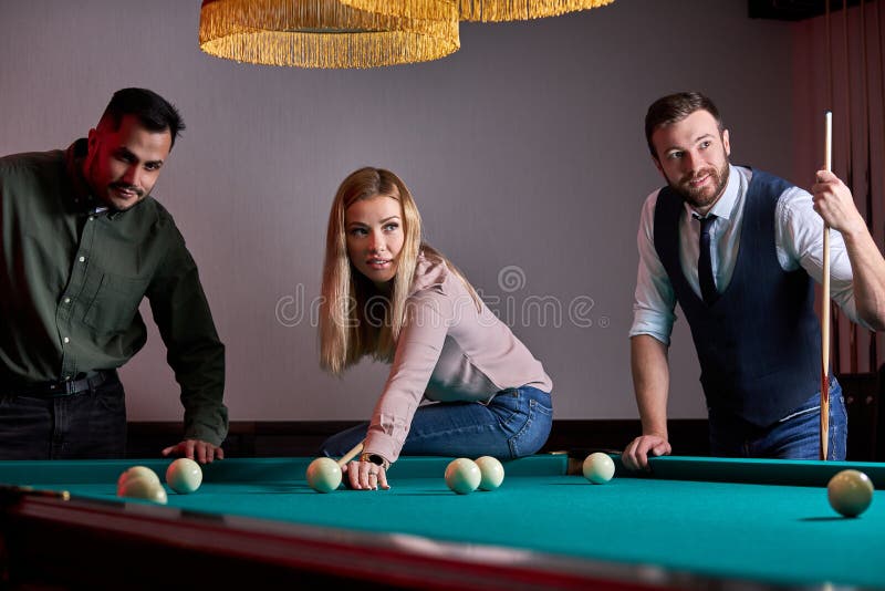 Three Friendly People Looking at Balls on Pool Billiards Table Stock ...