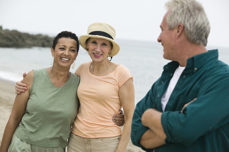 Three friends on beach stock photo. Image of vacations - 30839780