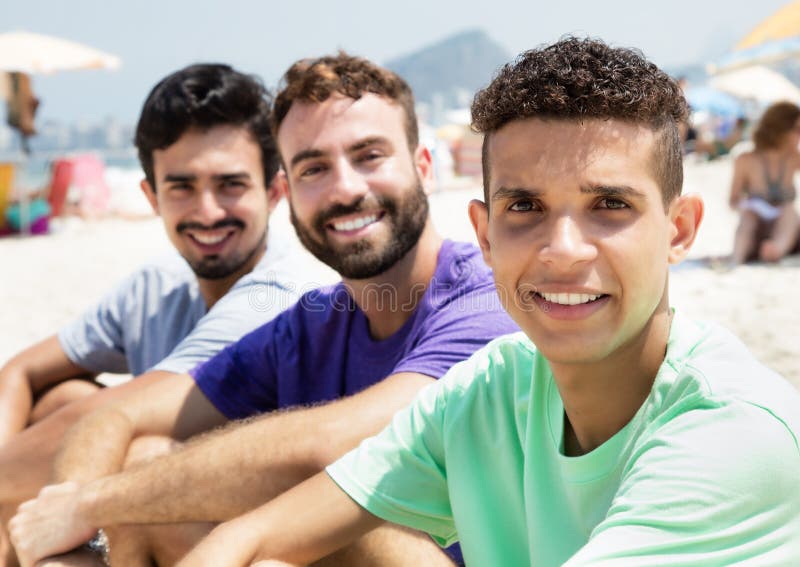 Three Friends at Beach Looking at Camera Stock Photo - Image of adult ...