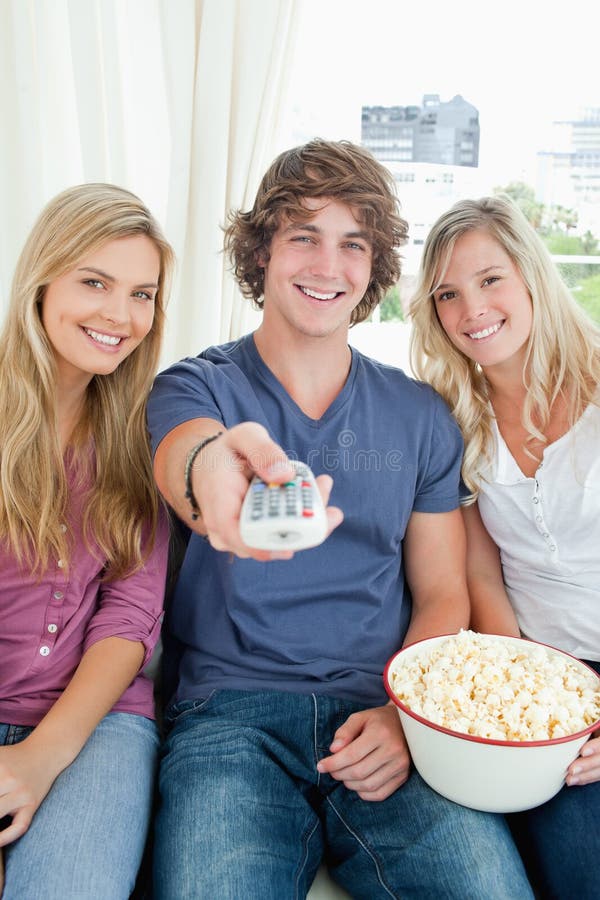 Three Friends Eating Popcorn Together Stock Image - Image of long ...