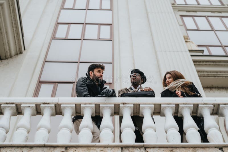 Three Friends Enjoying Time Together Overlooking from a Classic Balcony ...