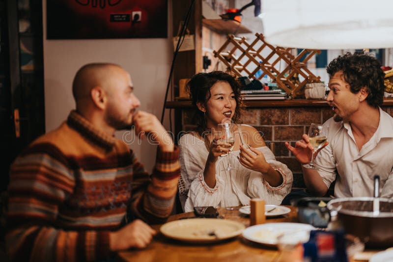 Group of Friends Enjoying Drinks and Conversation in a Cozy Indoor ...