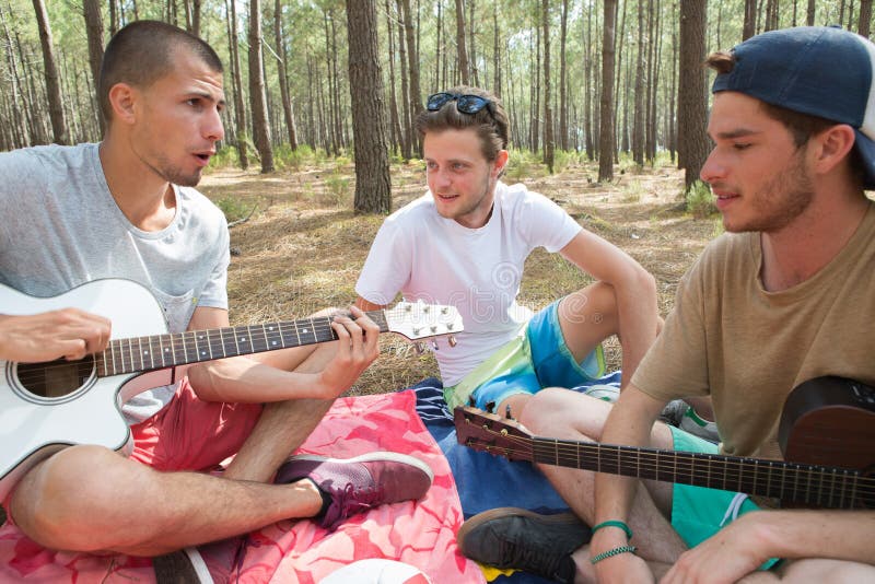 Three Friends Playing Football in Forest Stock Image - Image of summer ...