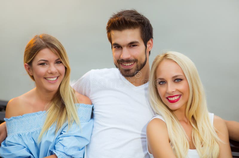Three friends having fun stock image. Image of bench - 76367711