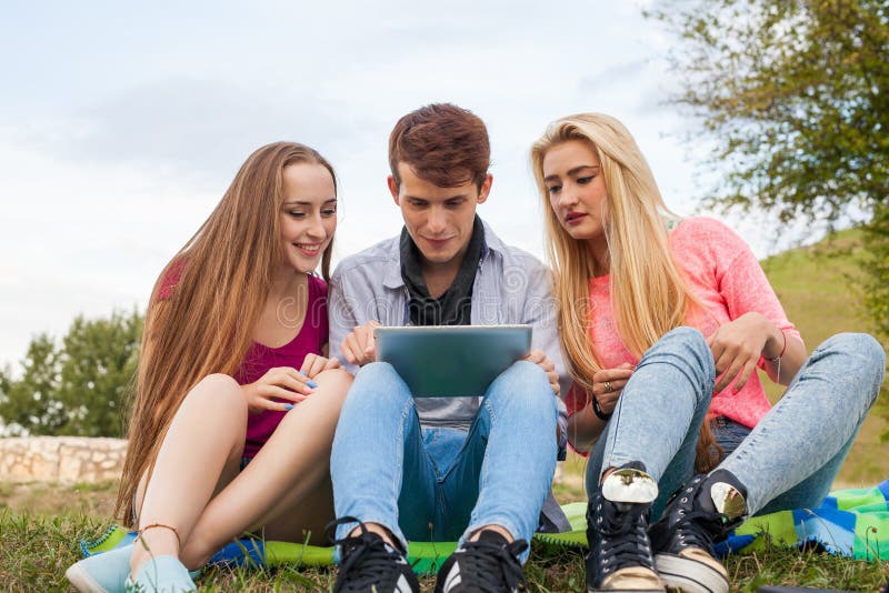 Three Friends Playing Game on Tablet Pc. they Winning Again. Stock ...
