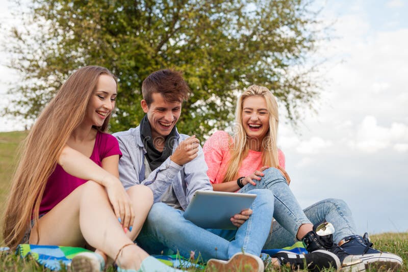 Three Friends Playing Game on Tablet Pc. they Winning Again. Stock ...