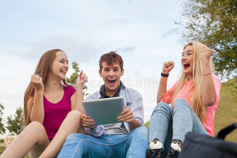 Three Friends Playing Game on Tablet Pc. they Winning Again. Stock ...