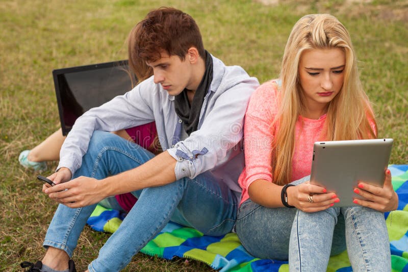 Three Friends Relaxing and Having Fun in Park. Stock Image - Image of ...