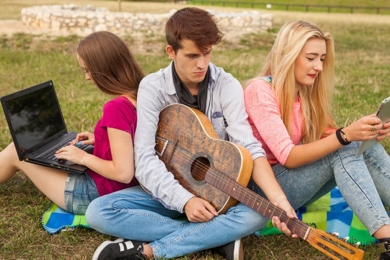 Three Friends Relaxing and Having Fun in Park. Stock Image - Image of ...