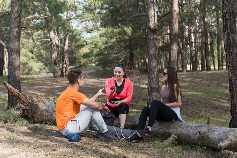 Three Friends Rest on a Fallen Log during a Hike Stock Image - Image of ...