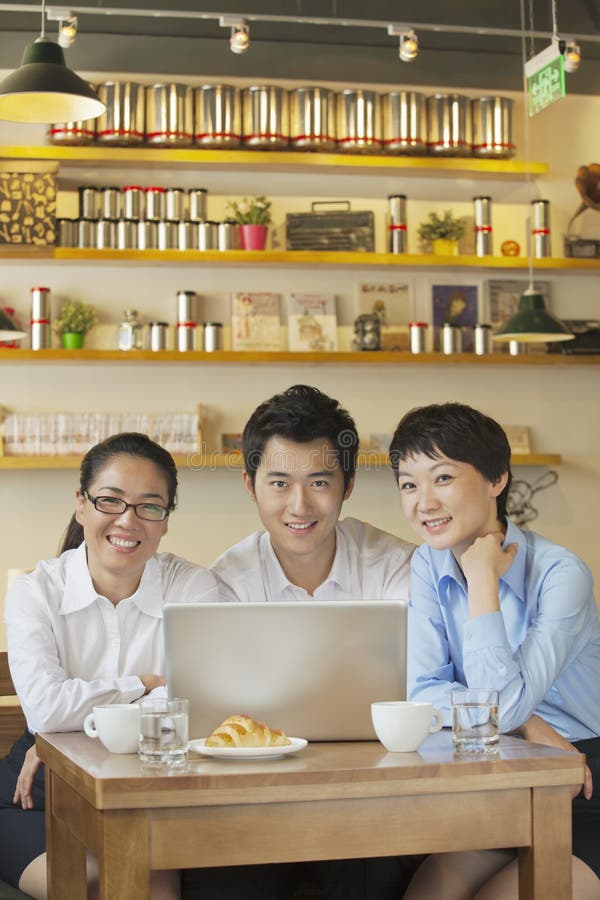 Three Friends Sitting in Coffee Shop, Looking at Camera Stock Image ...