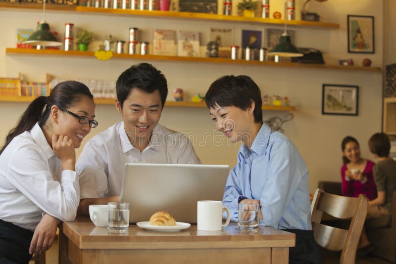 Three Friends Sitting in Coffee Shop, Looking at Camera Stock Image ...