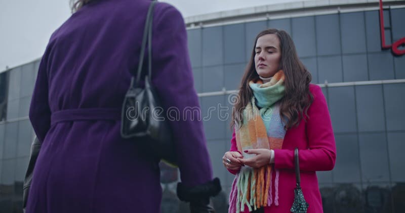 Three Female Friends Have a Serious Discussion on a City Sidewalk in ...