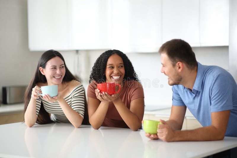 Three Friends Talking and Laughing in the Kitchen Stock Photo - Image ...