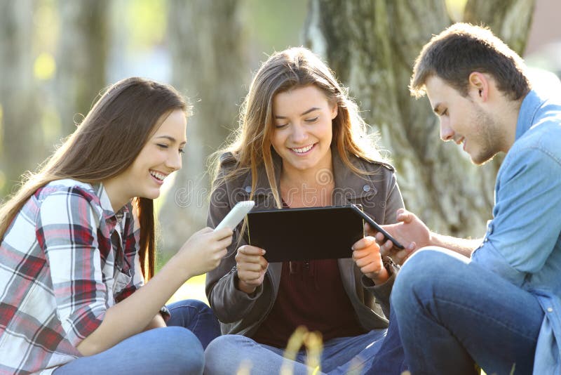 Three Friends Using Multiple Devices Stock Photo - Image of laughing ...