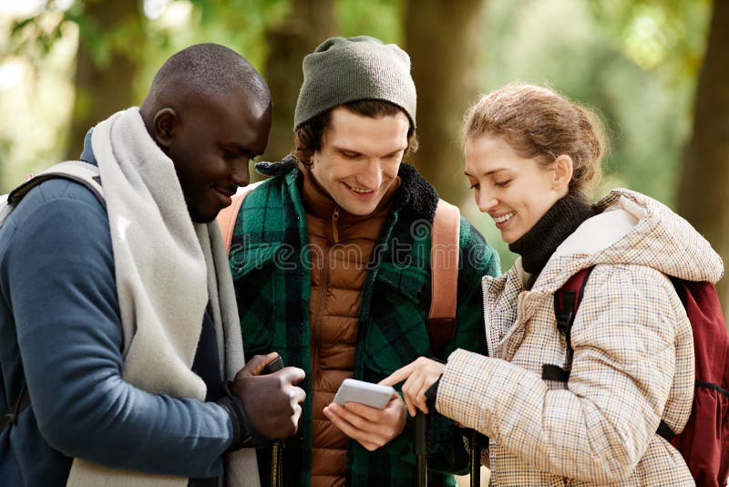 Three Friends Using Phone during Hike Stock Image - Image of smartphone ...