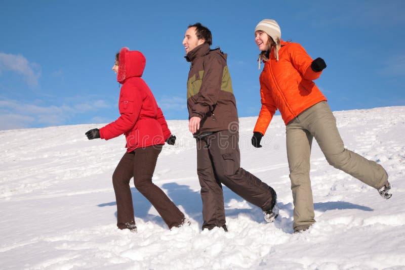 Three friends walk on snow stock photo. Image of descent - 4386742