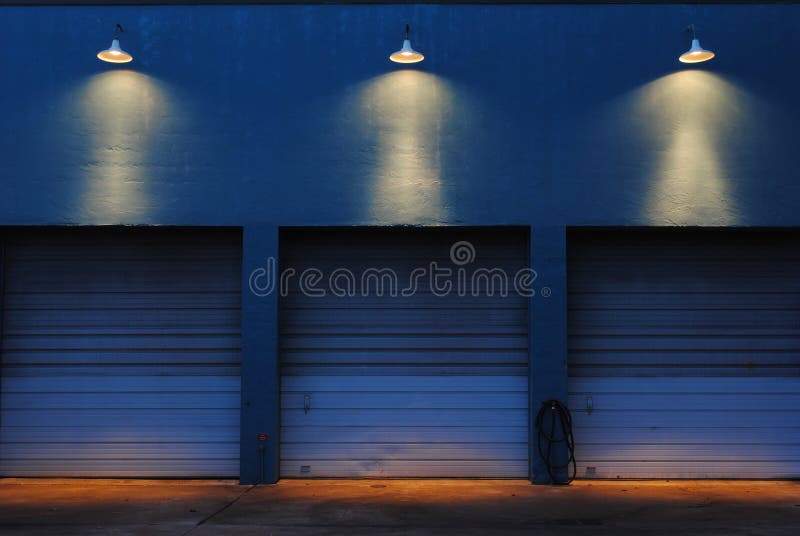Three Garage Doors at Night W Outdoor Lighting Stock Photo - Image of ...