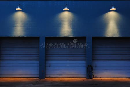 Three Garage Doors at Night W Outdoor Lighting Stock Photo - Image of ...