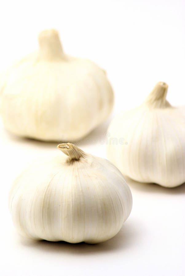 Three Raw Garlic Lie Side by Side on a White Background. Stock Image ...