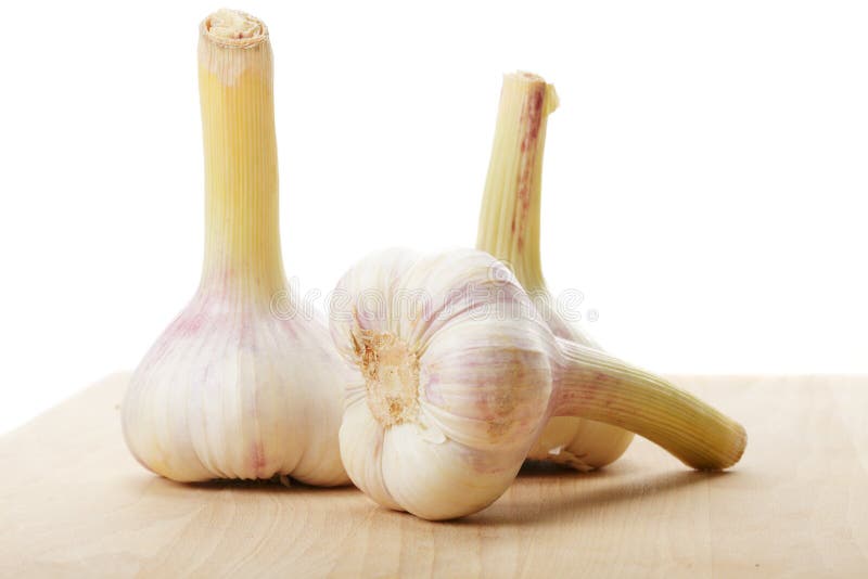 Three Raw Garlic Lie Side by Side on a White Background. Stock Image ...