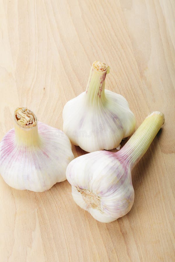 Three Raw Garlic Lie Side by Side on a White Background. Stock Image ...